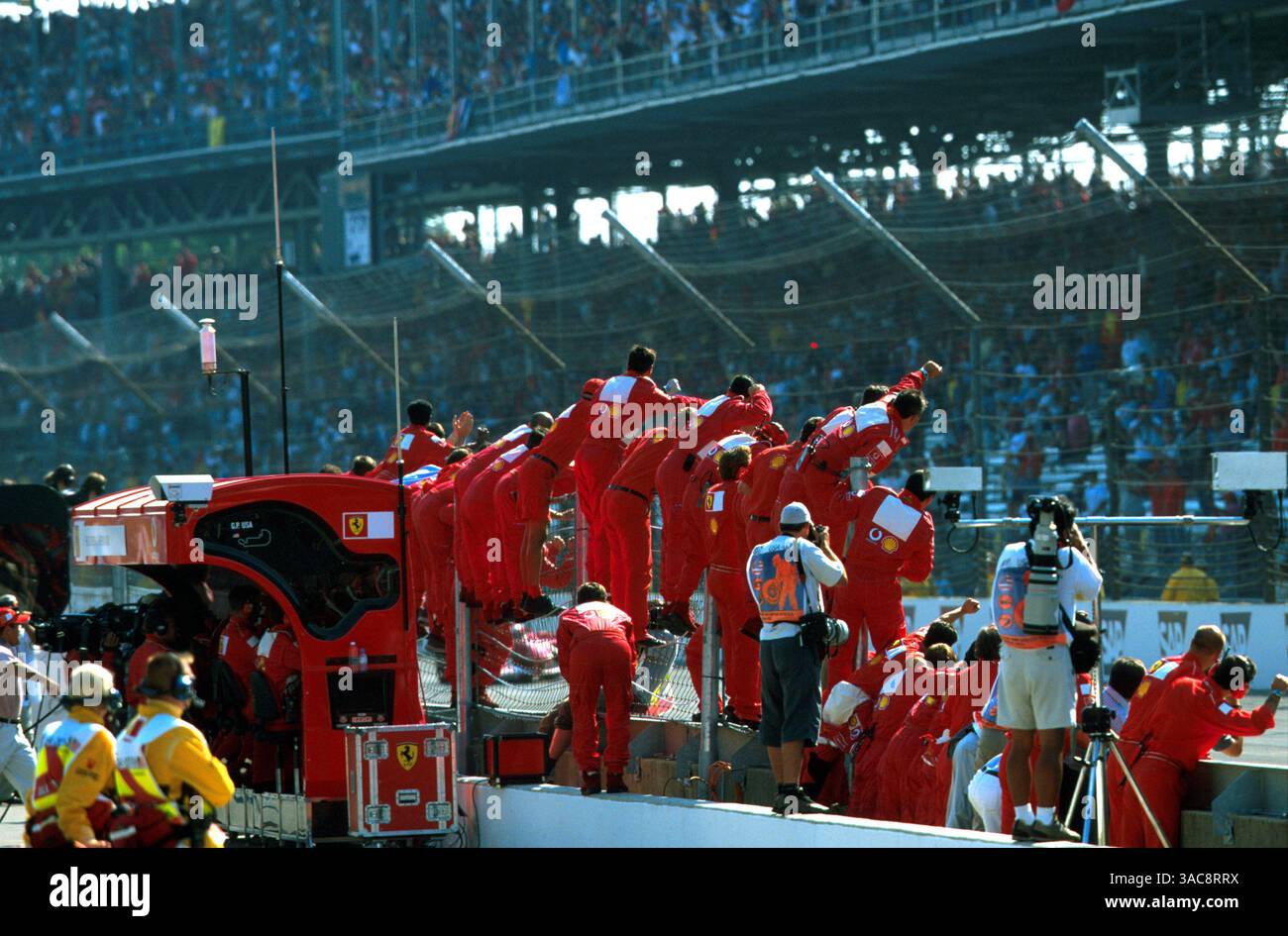 The Ferrari team stand on the pit wall to celebrate what was to be a ...