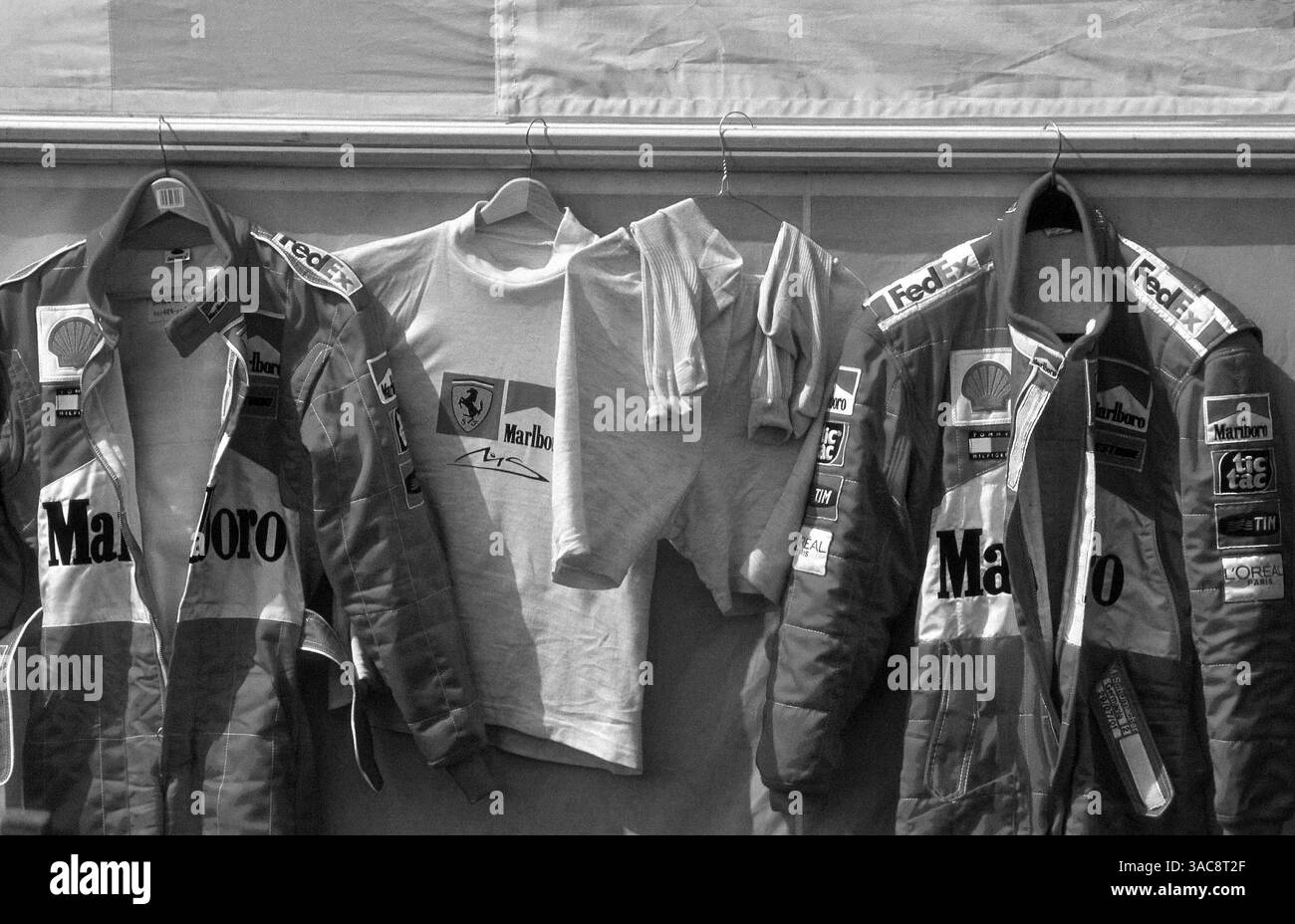 The Ferrari race overalls of Rubens Barrichello (BRA) (left) and ...