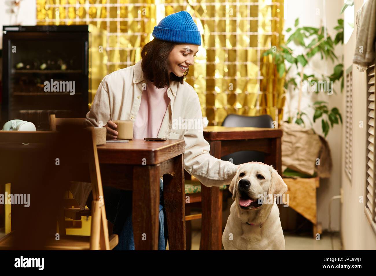 A young woman enjoys coffee while playfully interacting with her ...
