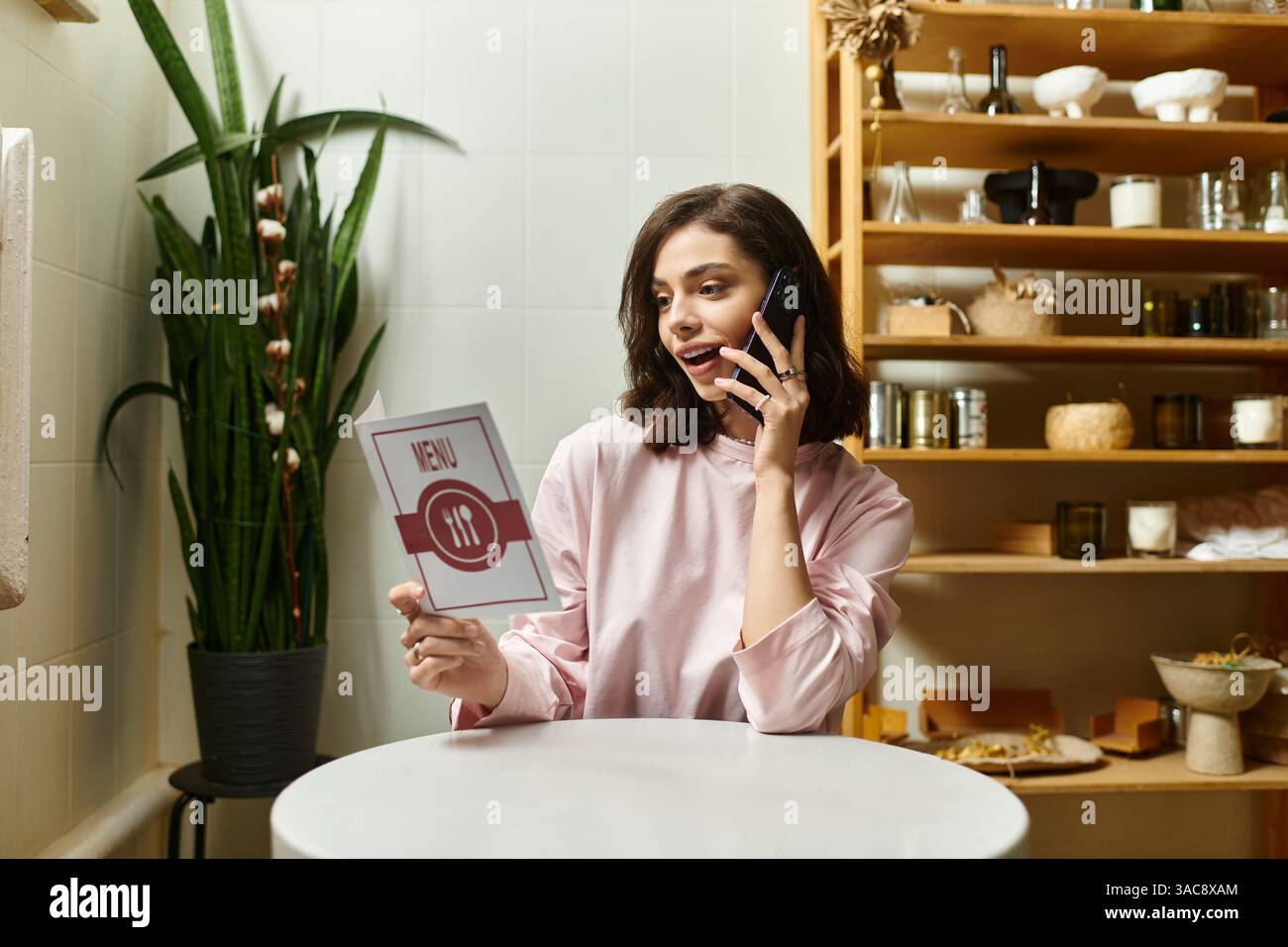 Young woman enjoys a delightful moment on the phone, exploring the menu ...