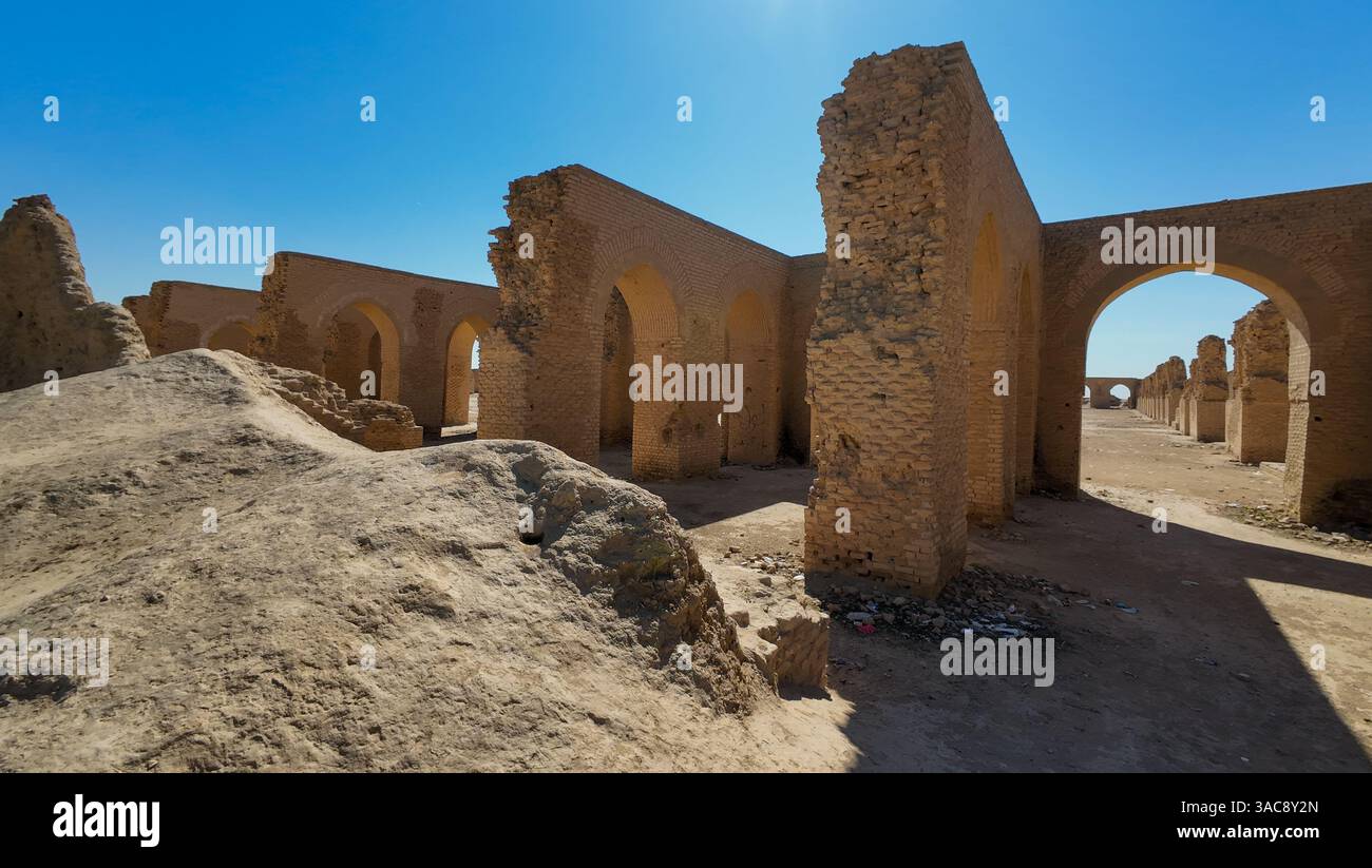 Ancient brick ruins with arches under a clear blue sky, surrounded by ...