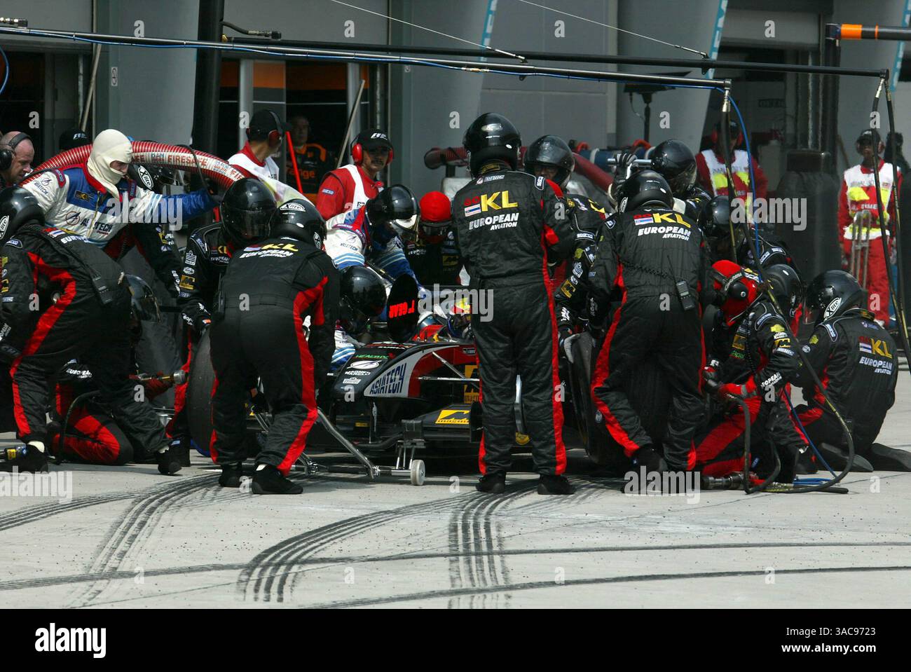 A pit stop for race retiree Mark Webber (AUS) Minardi PS02..Malaysian ...