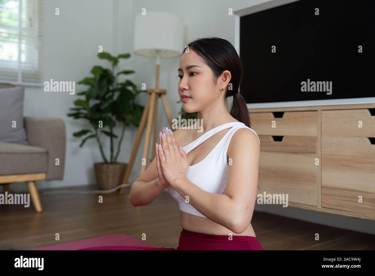 Mindfulness and Yoga Practice. A woman engages in a focused yoga session, promoting wellness and ...