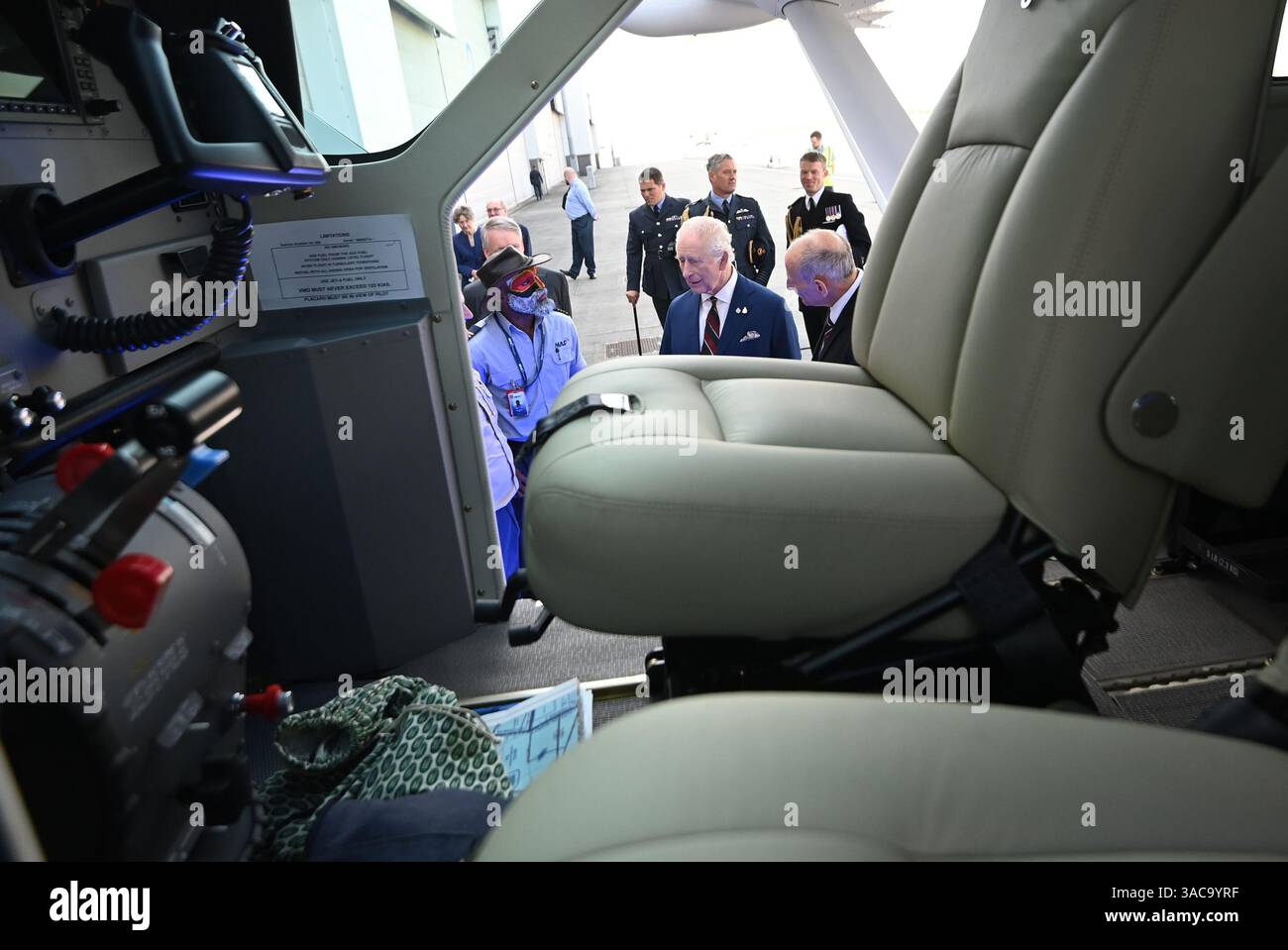 King Charles III inspects the Cessna with Pilot Joseph Tua during a ...