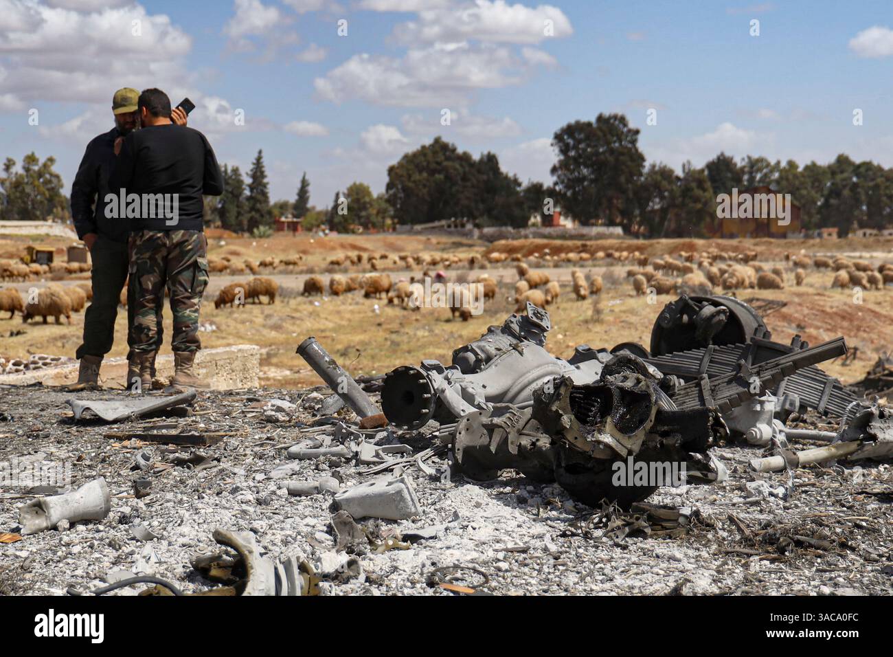 Two Syrian army officers inspect the site of an Israeli strike at a ...