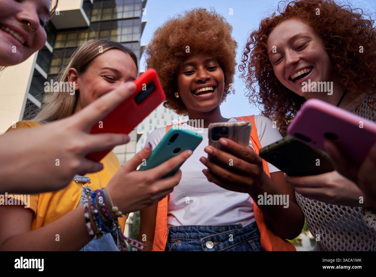Group of multiracial young women friends using smartphones addicted to ...