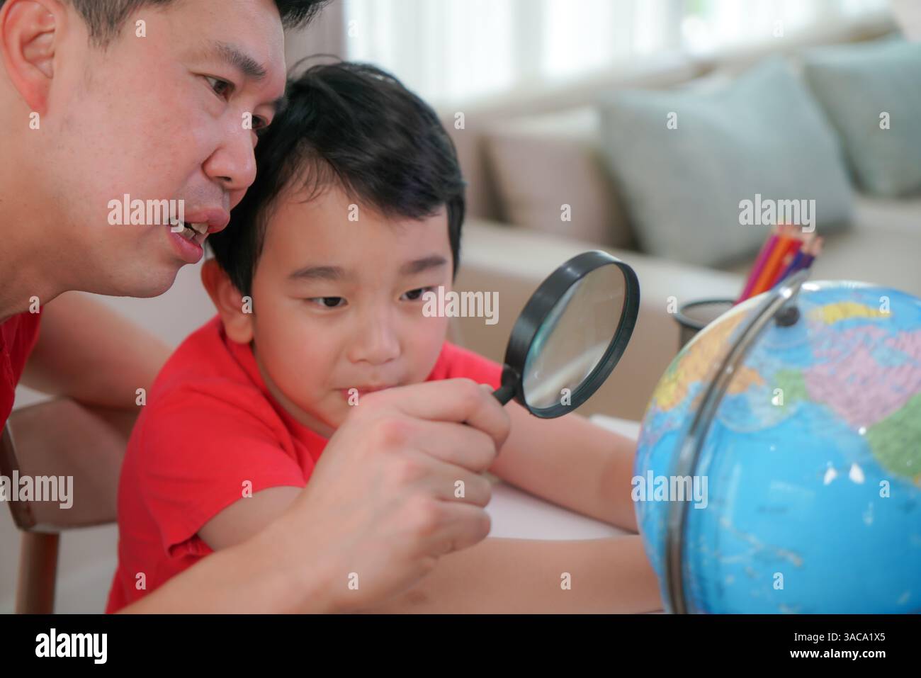 father and son explore the globe at home, nurturing curiosity, bonding ...