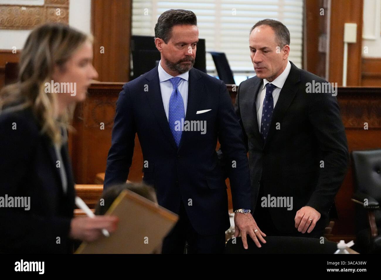 Defense attorney Alan Jackson returns from a sidebar meeting with ...