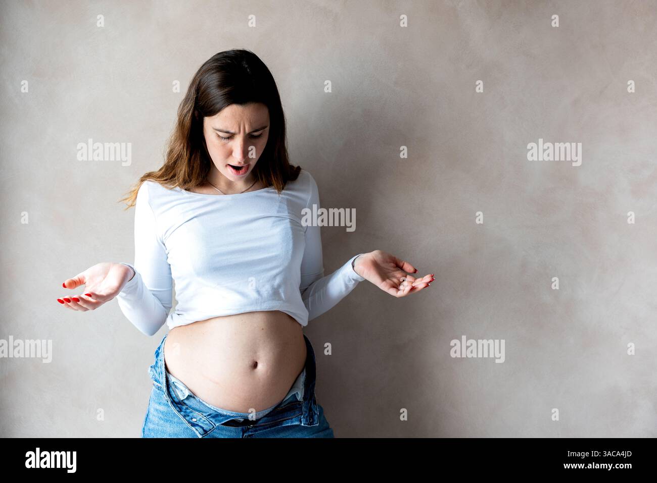 Woman with a bloated belly due to indigestion or pregnancy Stock Photo ...