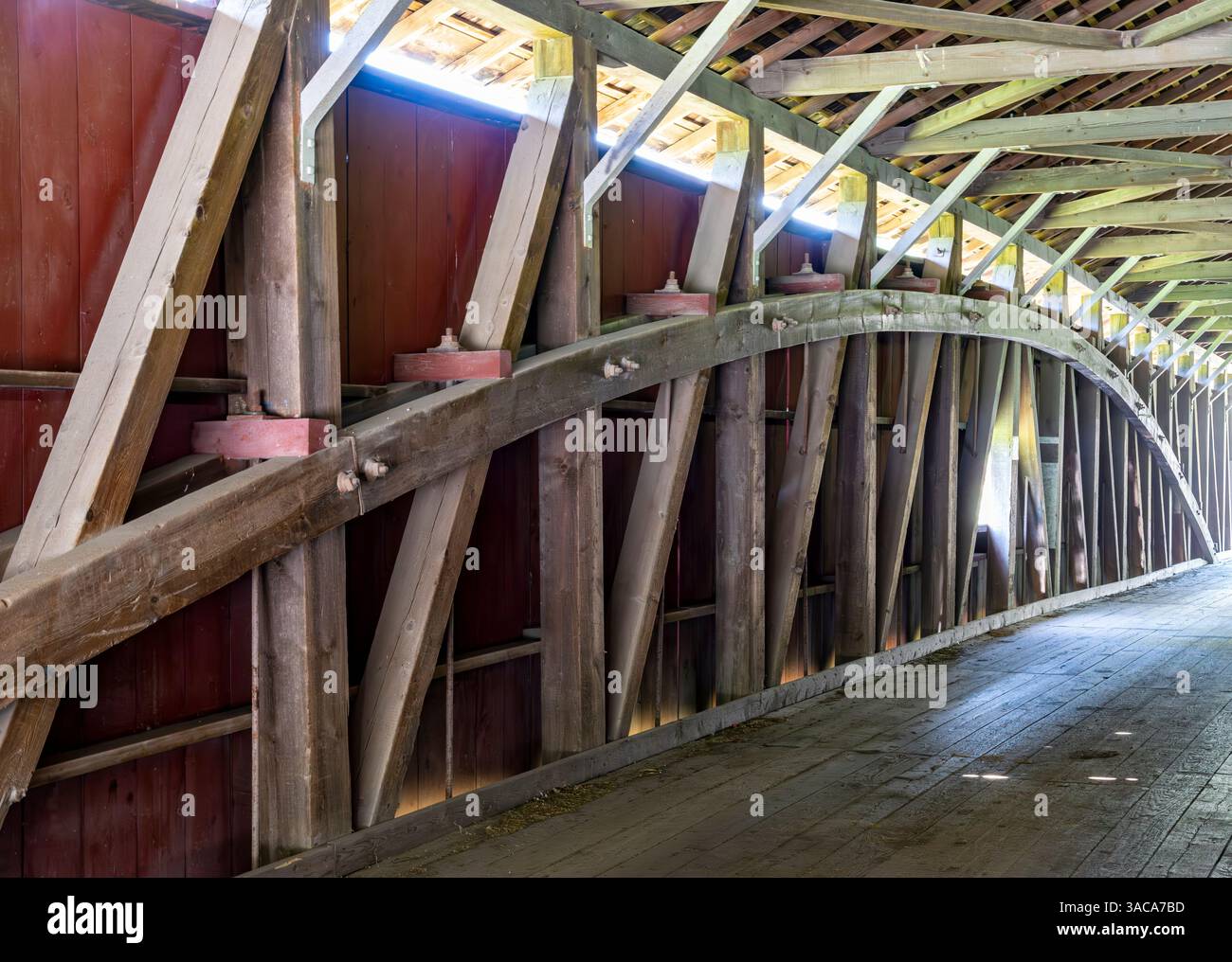 A stunning view of the interior structure of a covered bridge showcases ...
