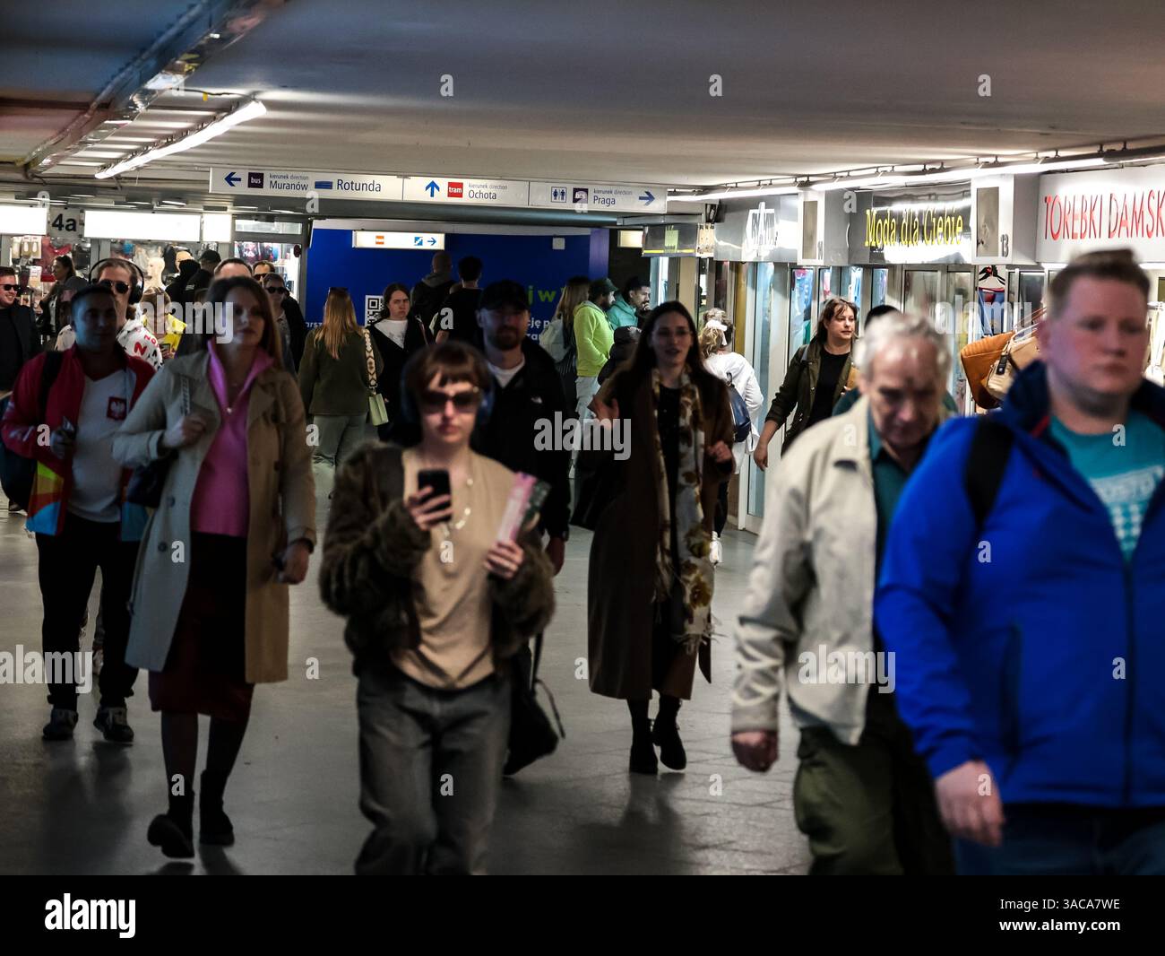 People walk in the underground pathway in central Warsaw, the capital ...