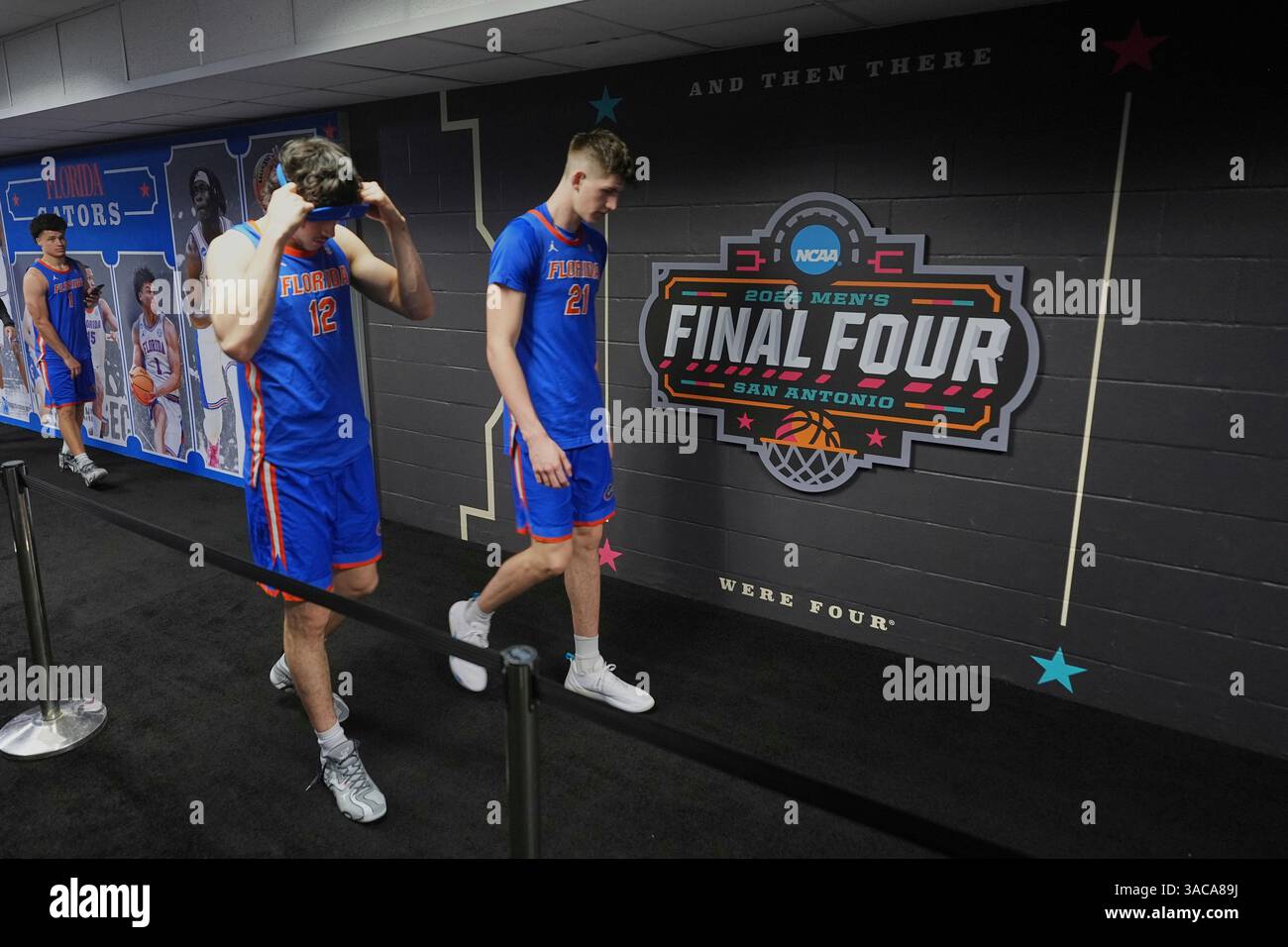Florida's Viktor Mikic (12) and Alex Condon (21) walk to the court ...