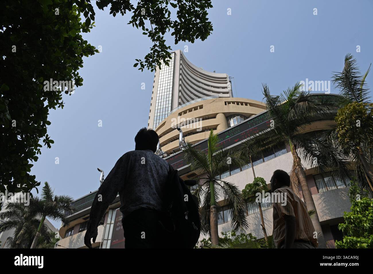 Mumbai, India. 03rd Apr, 2025. People walk below the Bombay Stock ...