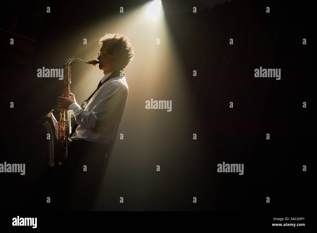 Side view of professional male jazz musician in white shirt playing ...