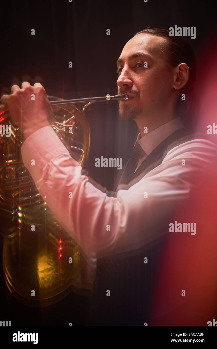 Vertical long exposure shot of professional male musician in formal ...