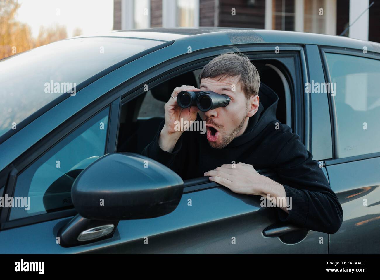 Young shocked man stalker hi-res stock photography and images - Alamy