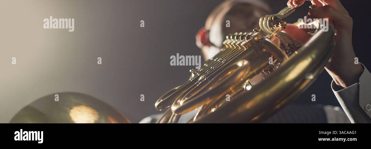 Website header shot of male jazz musician pushing valve levers of ...