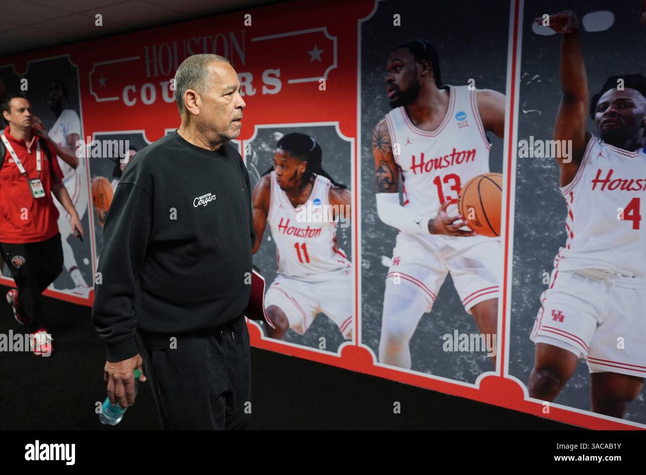 Houston head coach Kelvin Sampson walks past the team's locker room ...