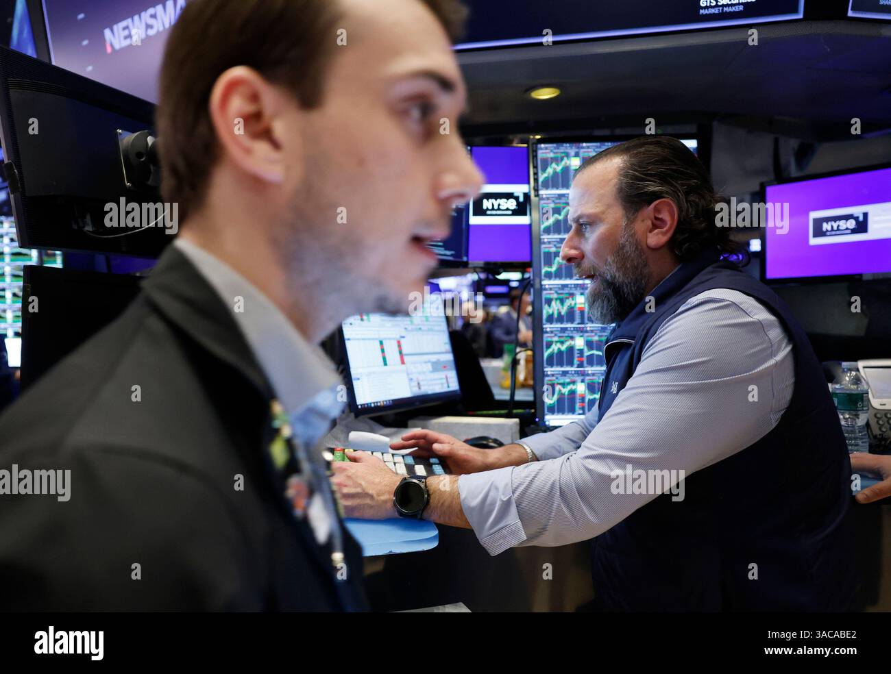 New York, United States. 03rd Apr, 2025. Traders work on the floor of ...