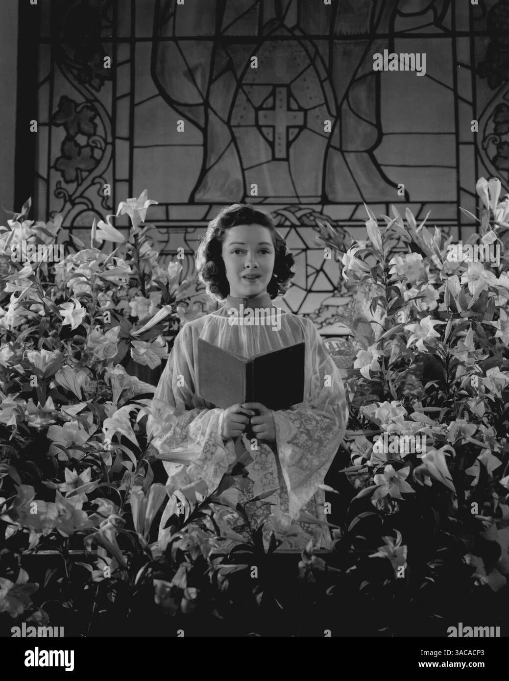 Kathryn Grayson greets Easter with a song...... as he stands surrounded ...