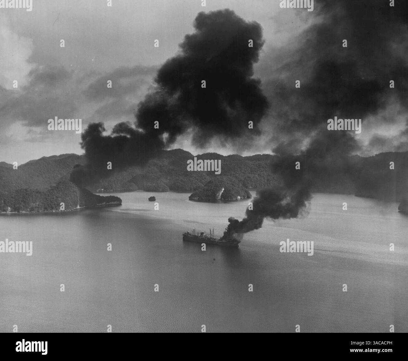 Japanese ship ablaze in Palau Harbor during Pacific Fleet's carrier ...