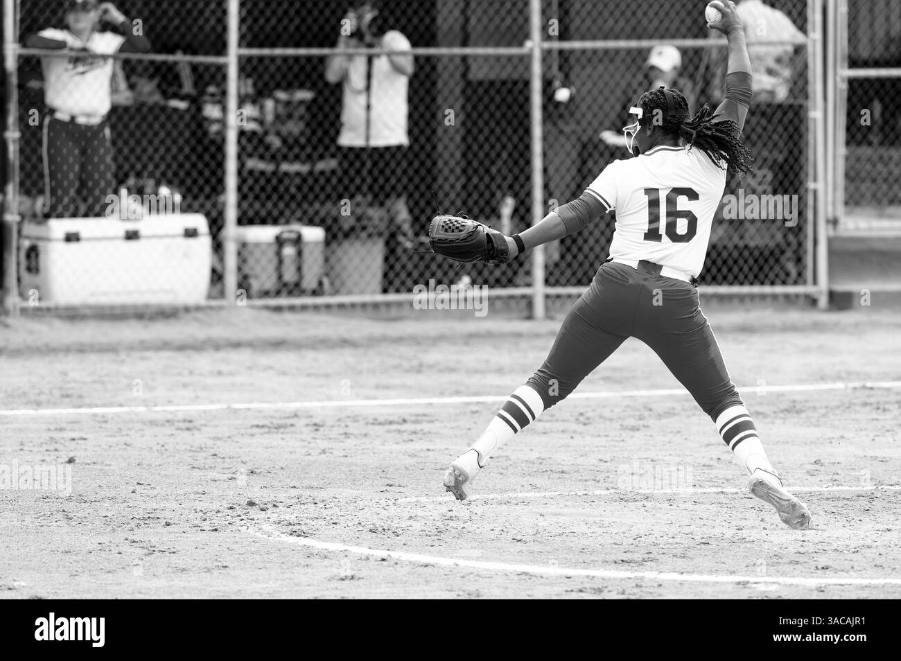 A Fast Pitch Softball Pitcher Is In Full Wind Up Pitching The Ball To ...
