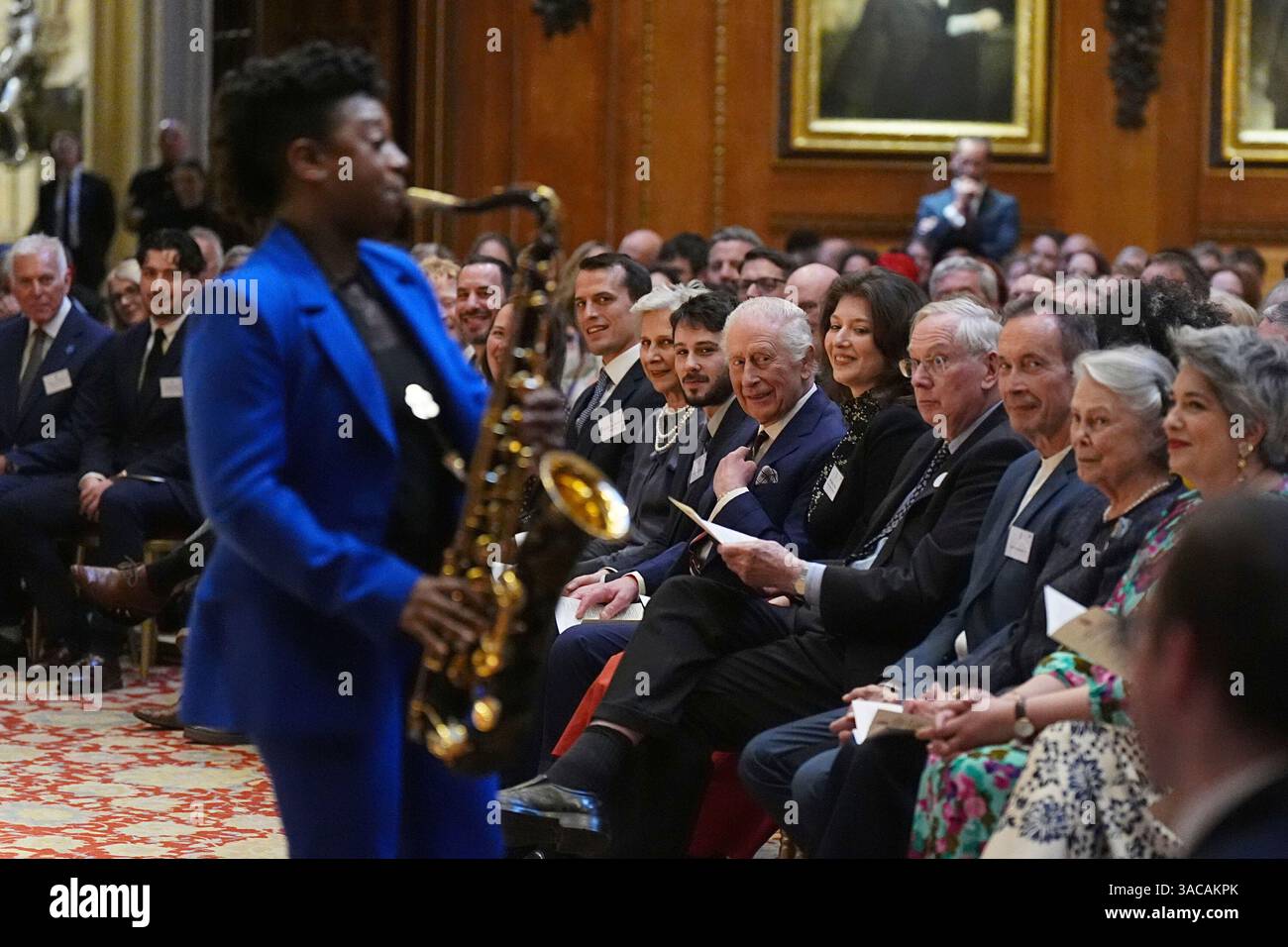 Britain's King Charles III, center right, watches a performance by ...