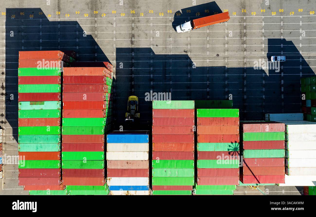 Cargo containers line a shipping terminal at the Port of Oakland on ...