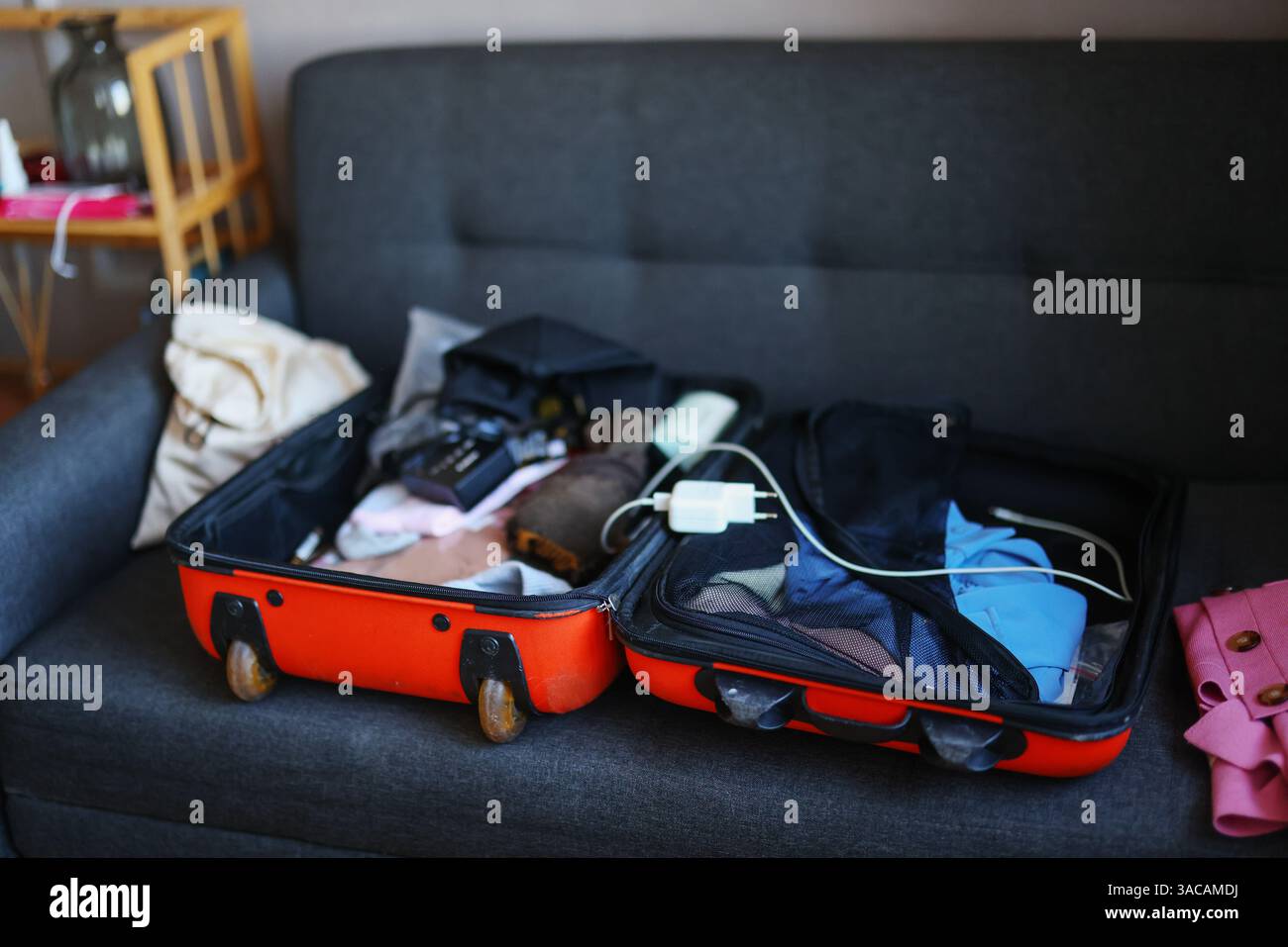 Open suitcase with clothes and personal things packed for travelling ...