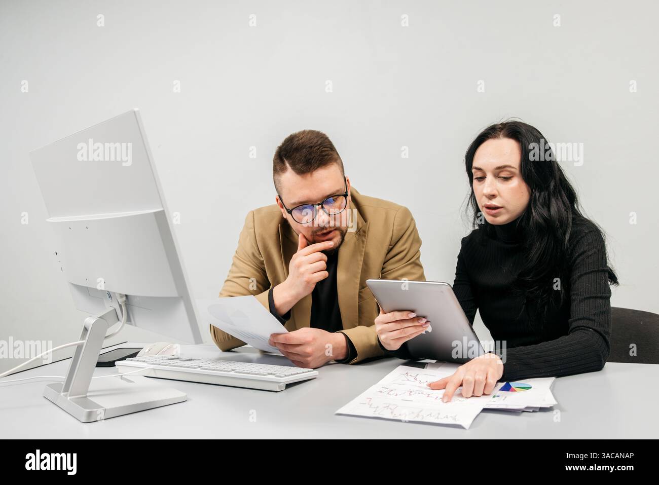 Two members of a finance team working together on a project during a ...