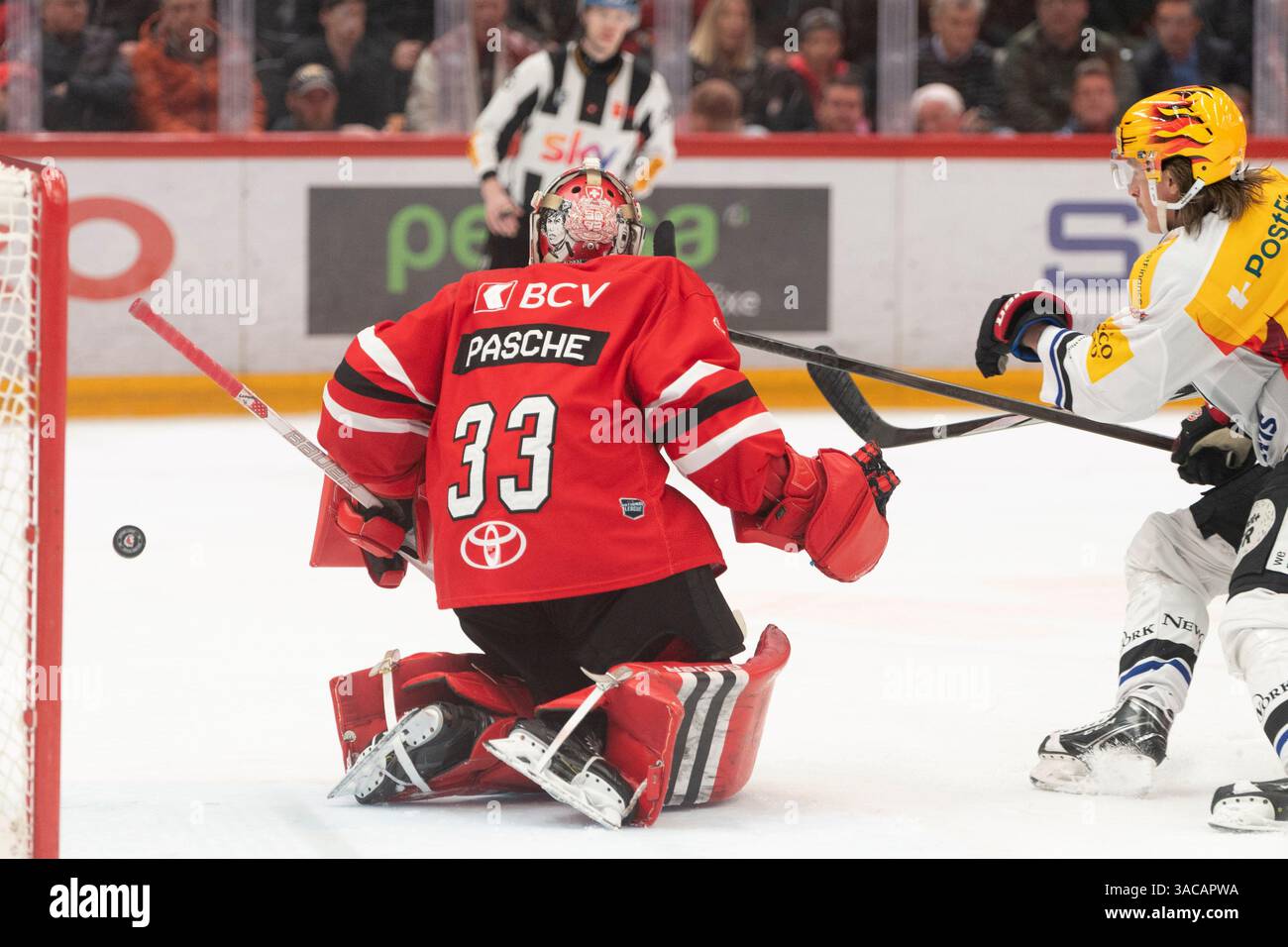 Lausanne, Switzerland. , . Kevin Pasche (goalkeeper) of Lausanne HC #33 deflects the puck during ...