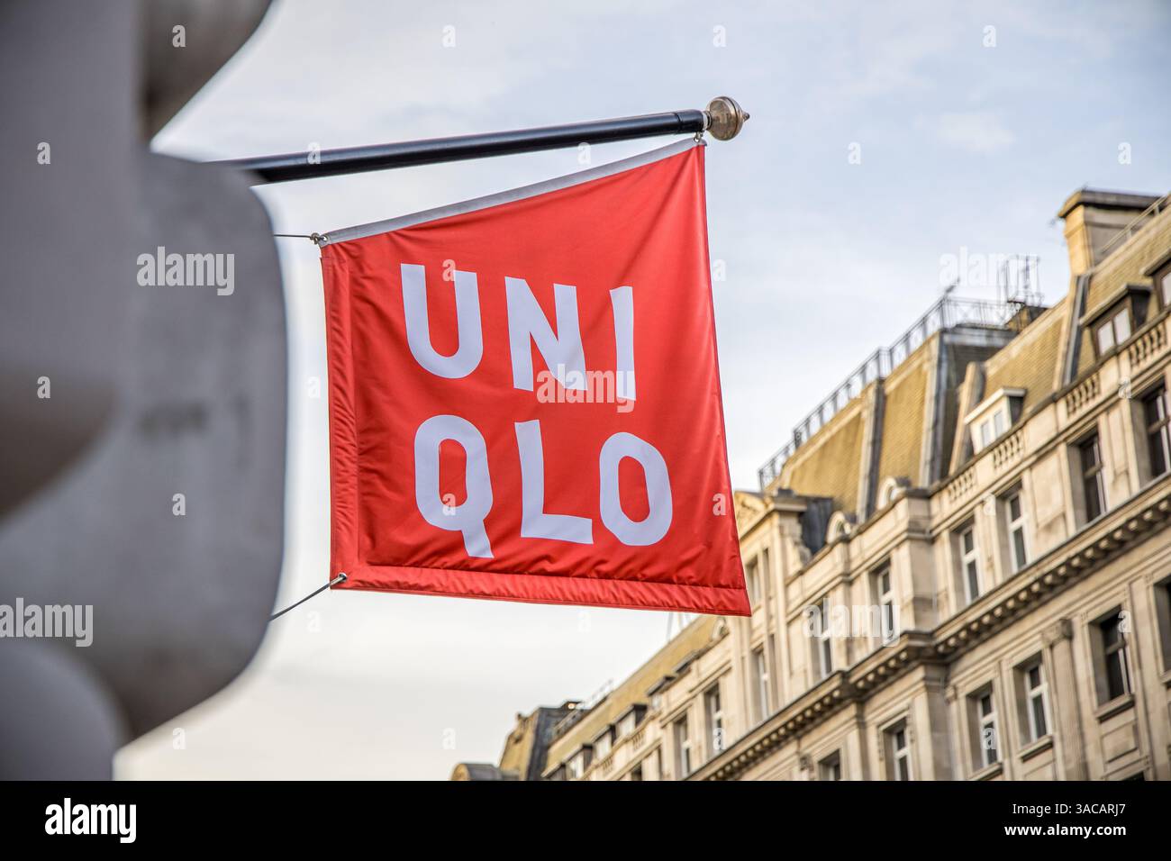London, UK - September 14, 2023: UNIQLO Japanese shop logo red flag ...
