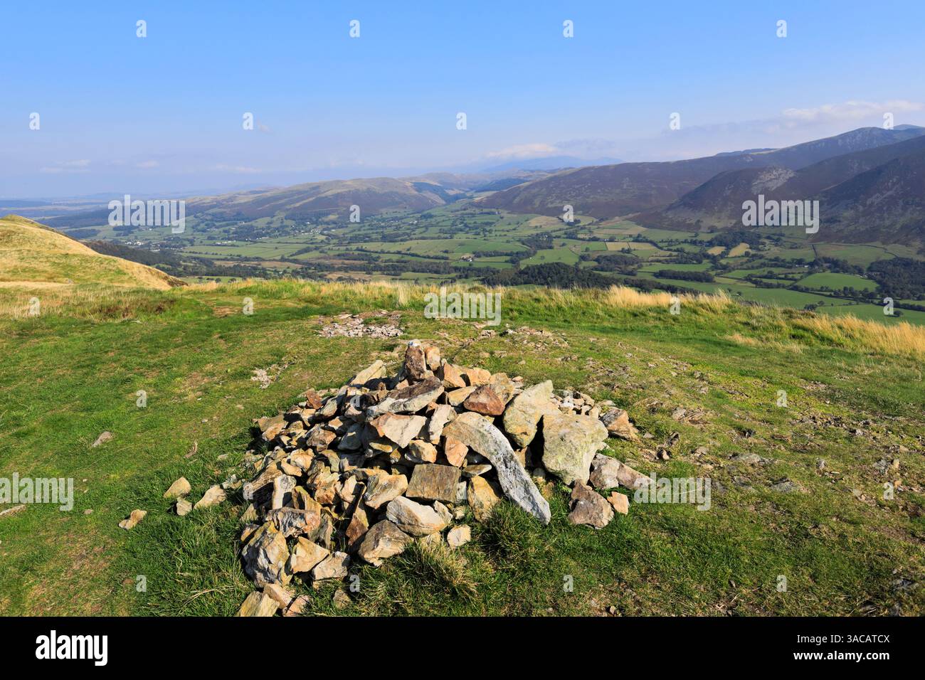 View of the summit cairn of Low fell, above the Vale of Lorton, Lake ...