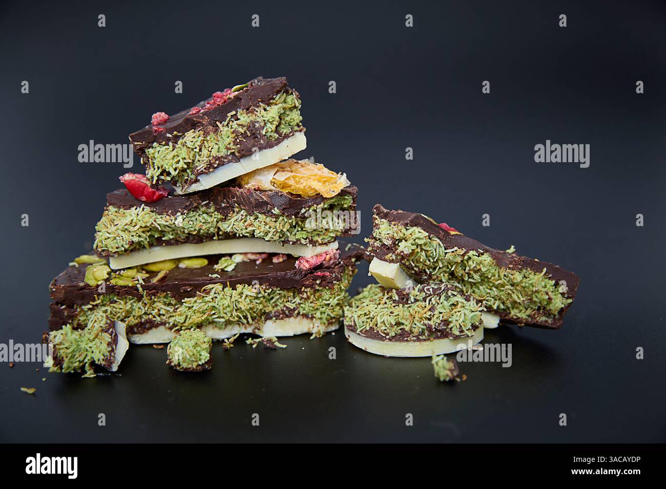 Dubai chocolate. Luxury dark chocolate bark, adorned with emerald pistachio and ruby red fruit ...