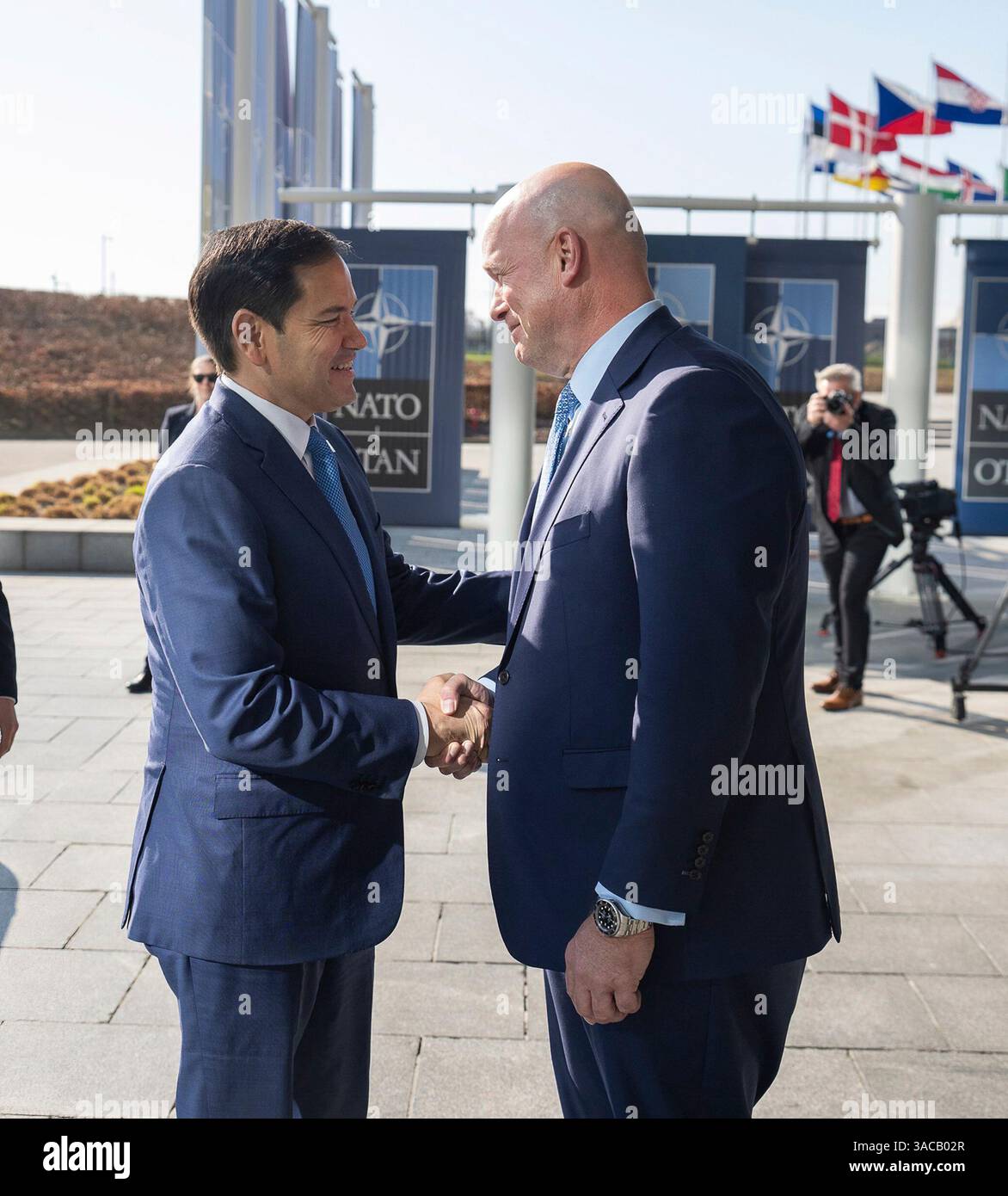 Secretary Marco Rubio is greeted by U.S. Ambassador to NATO Matthew ...