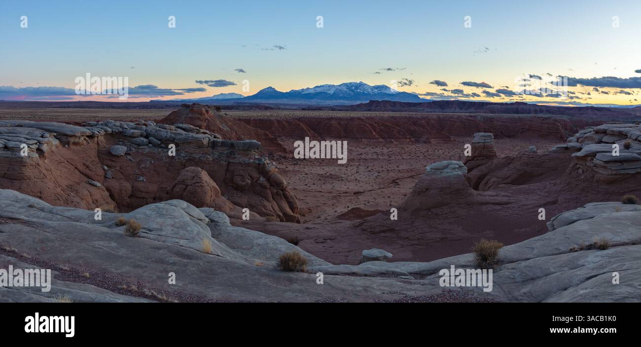 Twilight on the colorful rugged Utah Badlands and snow covered Henry ...