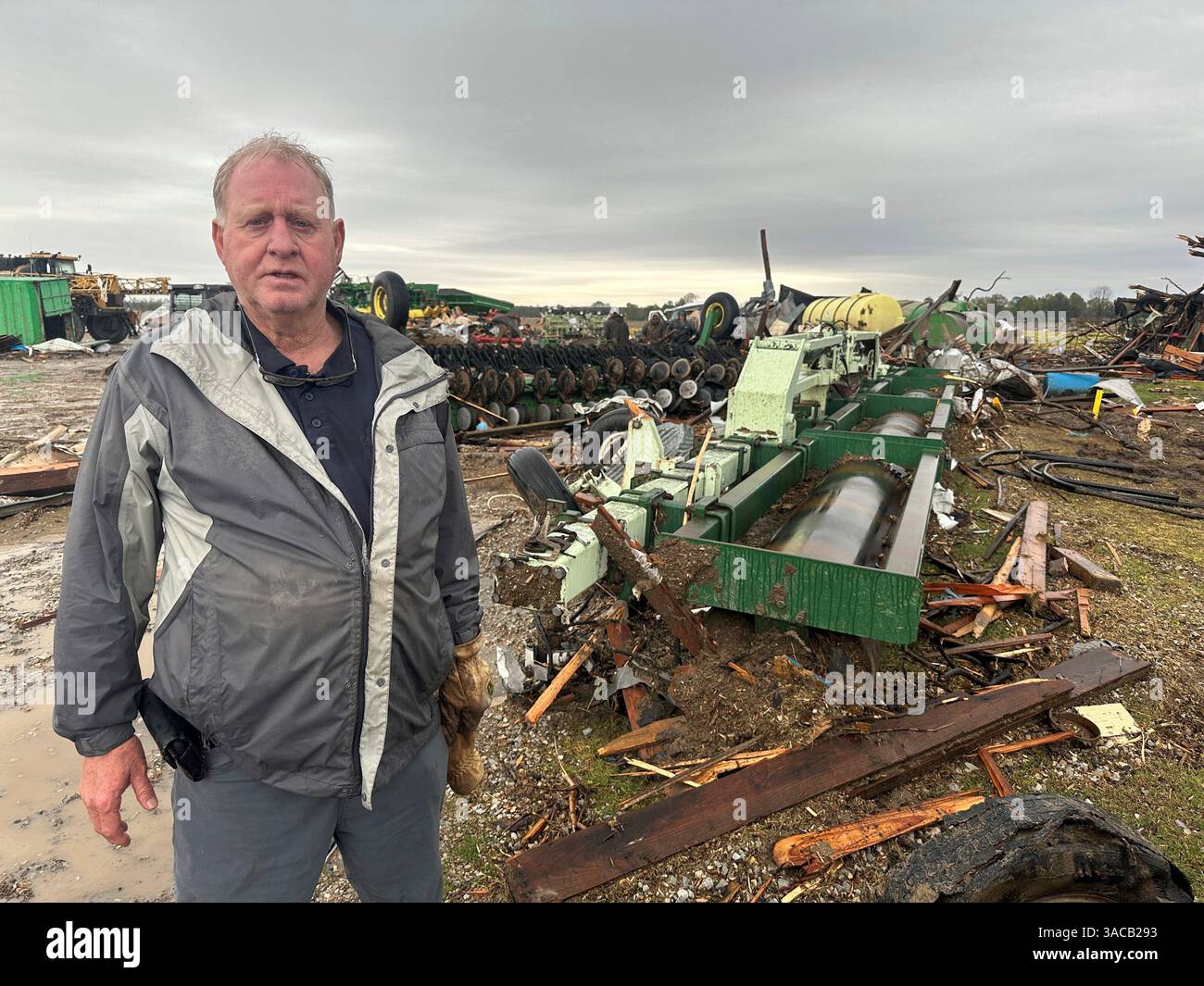 Danny Qualls speaks with a reporter about damage to his family farm on ...
