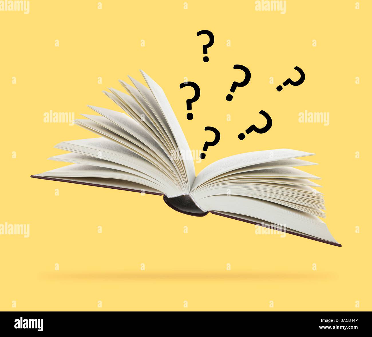 Question marks over open book on pale yellow background Stock Photo - Alamy
