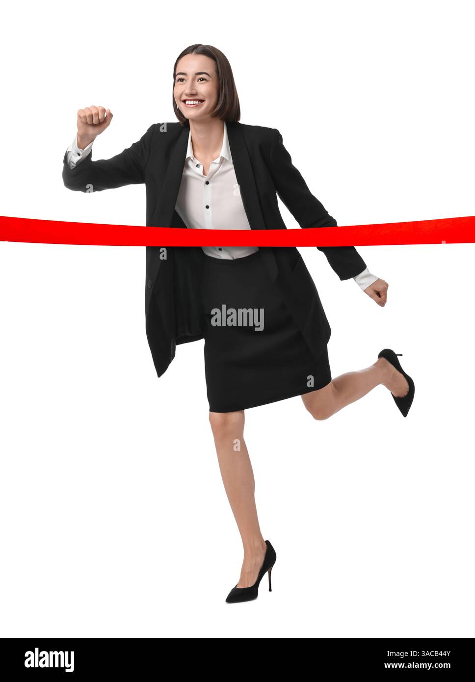 Happy businesswoman crossing red finish line ribbon on white background ...