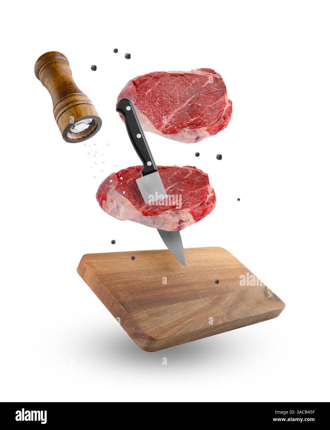Cutting board, knife, pepper mill and raw meat in air on white ...