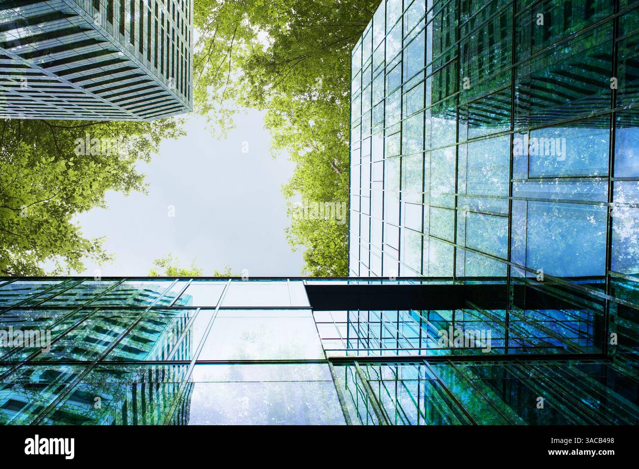 Modern buildings and lush trees against blue sky, double exposure. View ...