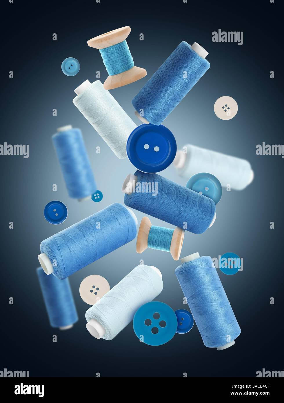 Many sewing threads in different shades of blue flying on dark gradient ...