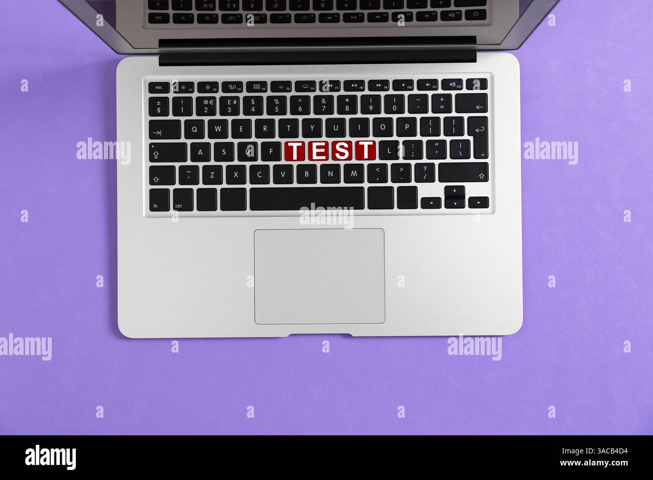 Online test. Laptop keyboard with buttons making word Test on violet ...