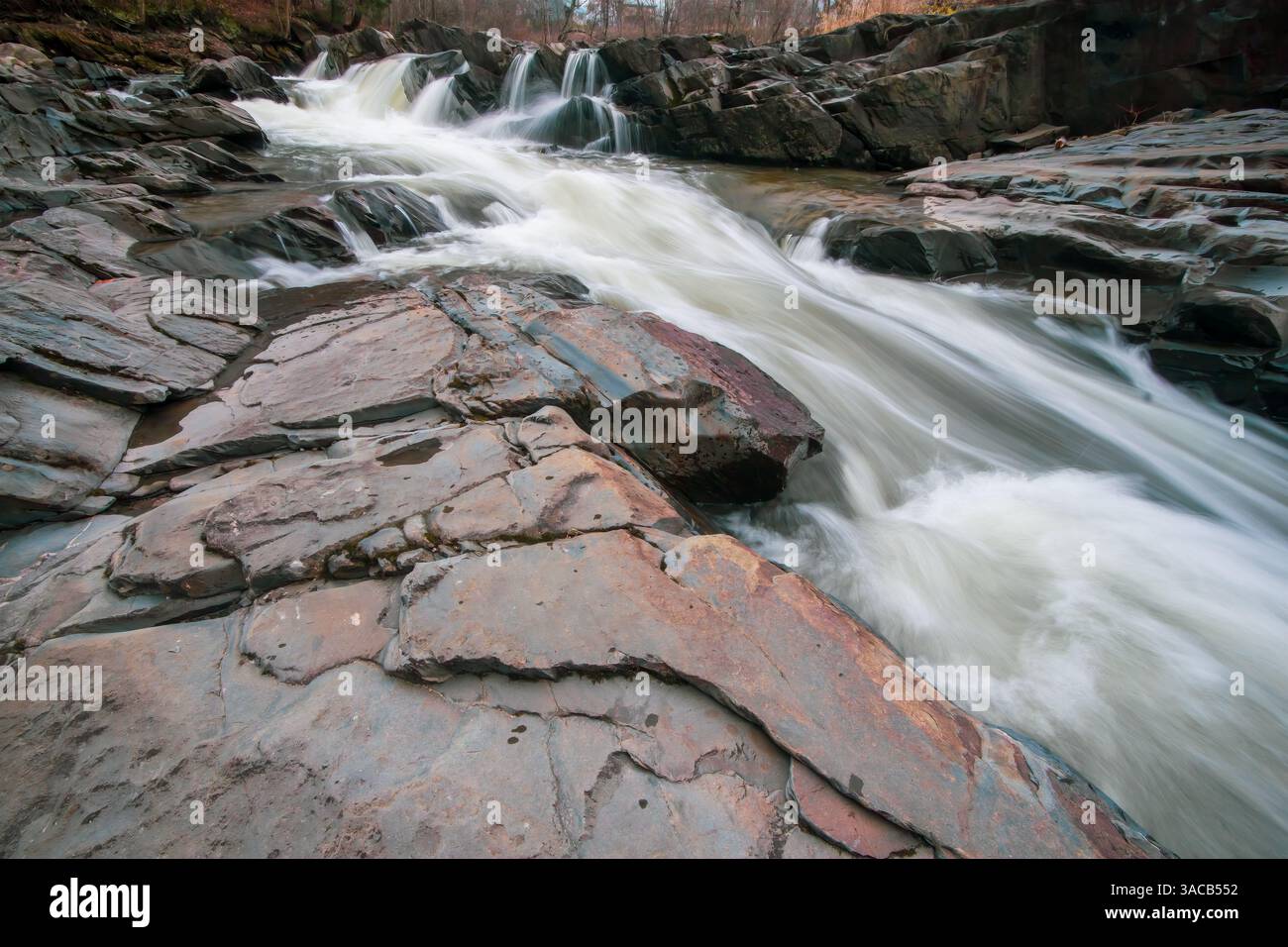 Fast moving water cacades over detailed rocks Stock Photo - Alamy