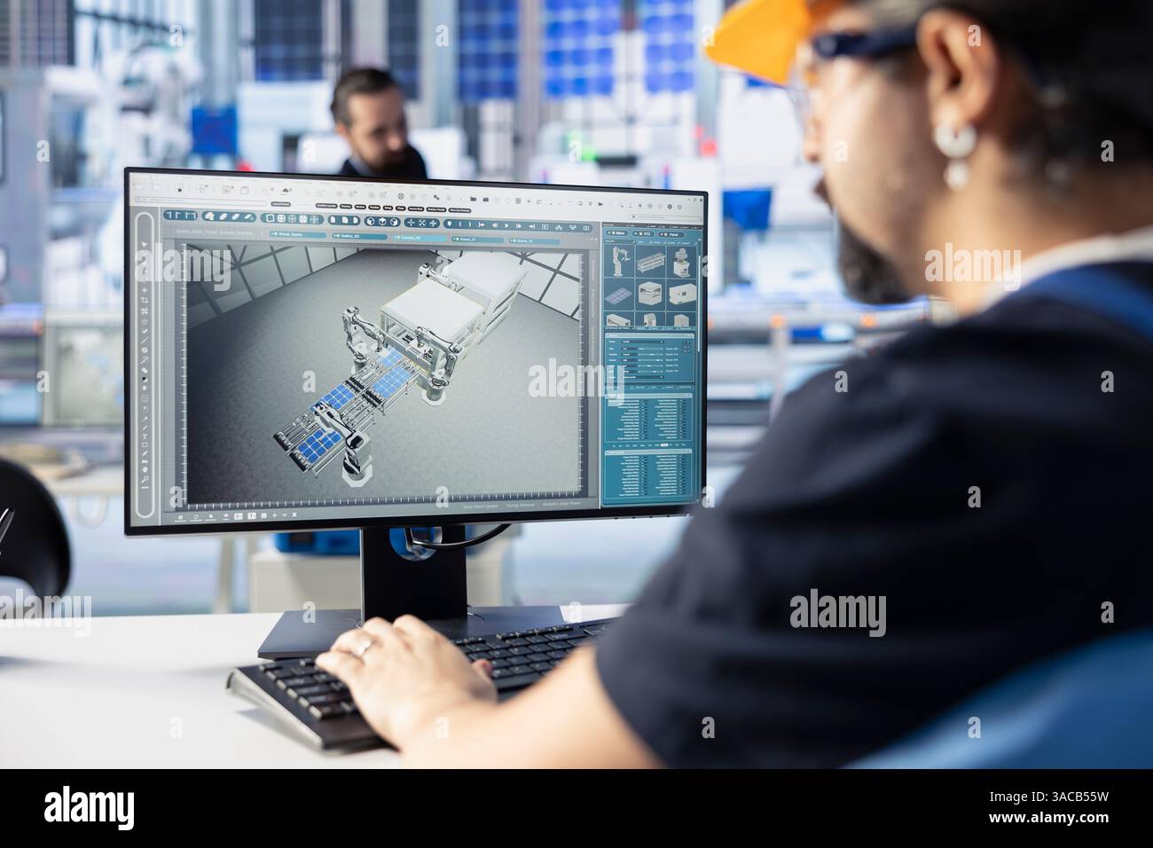 Industrial automation engineer in solar panel plant adjusting robotic machinery settings through ...