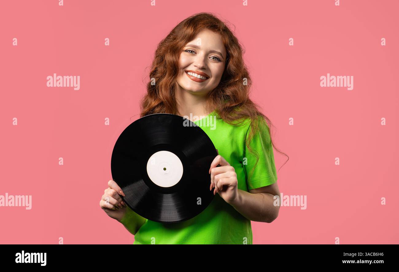 Pretty woman dancing with vinyl record disc on pink. Hobby, music ...