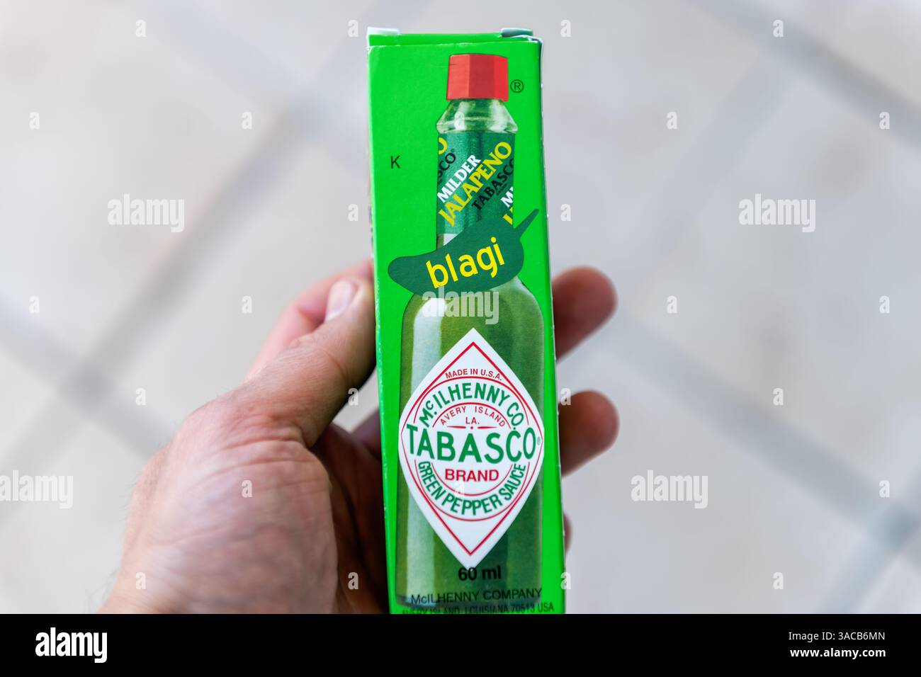 Budva, Montenegro - July 29, 2023: Hand holding green tabasco label ...