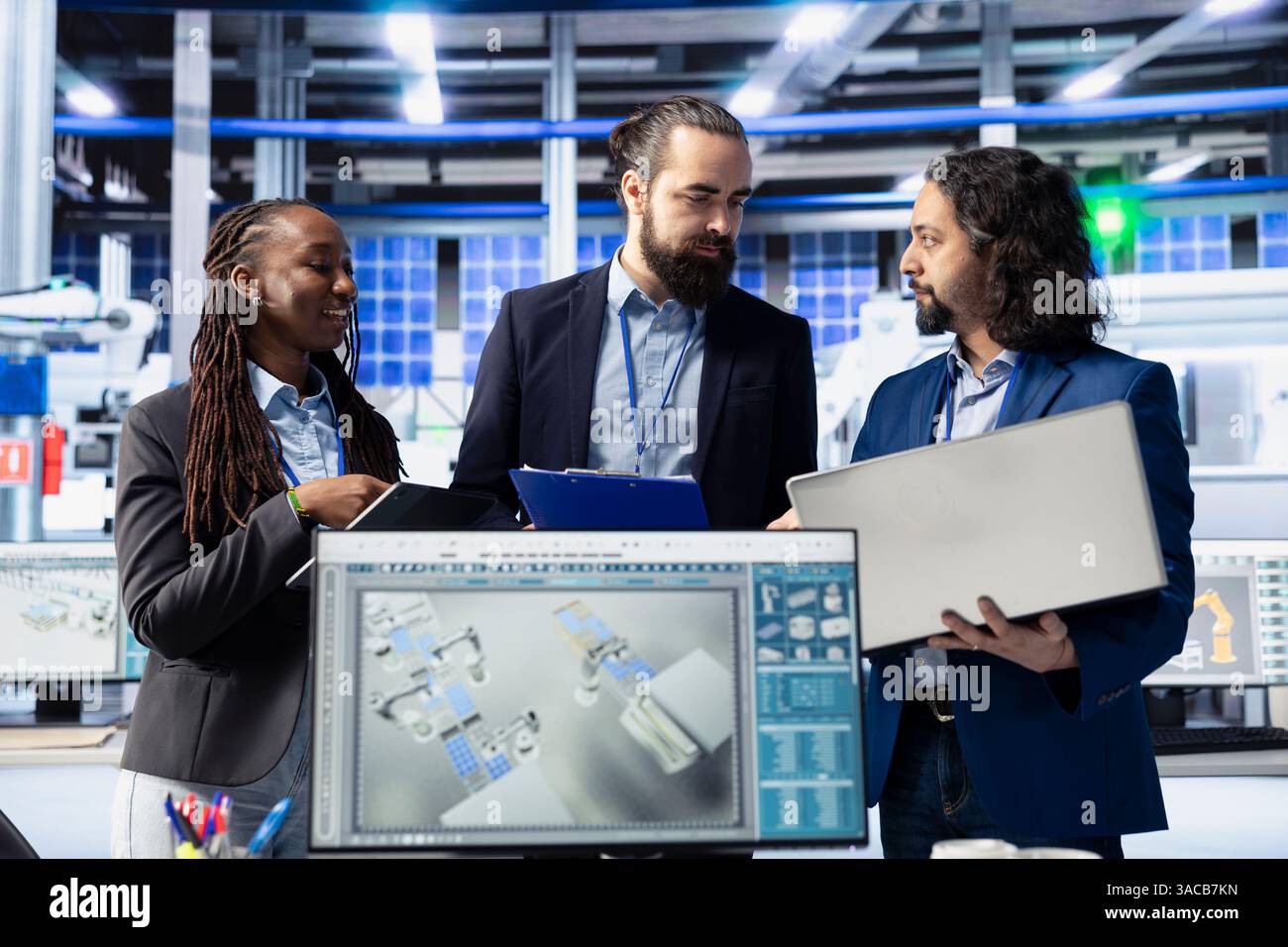 Engineering team in solar panel plant adjusting robotic machinery ...