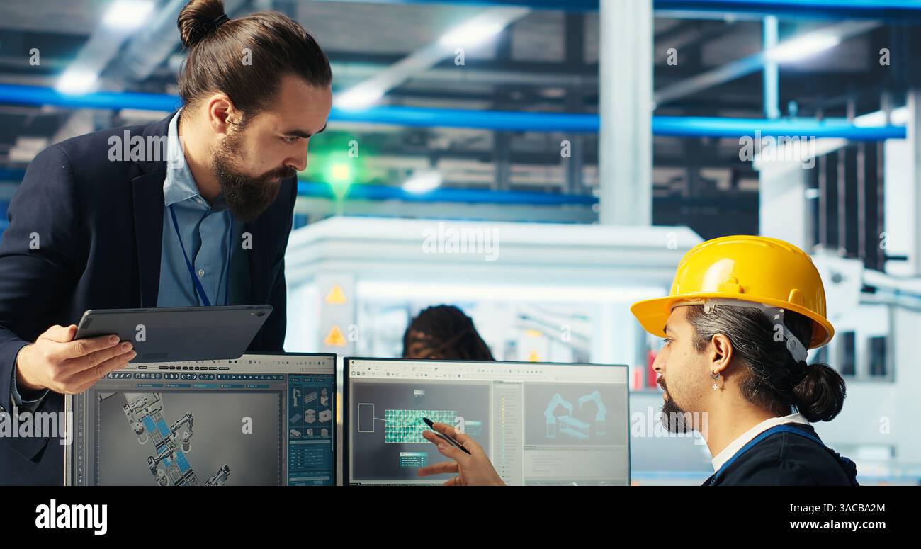 Photovoltaics factory engineer planning work on facility floor in CAD ...