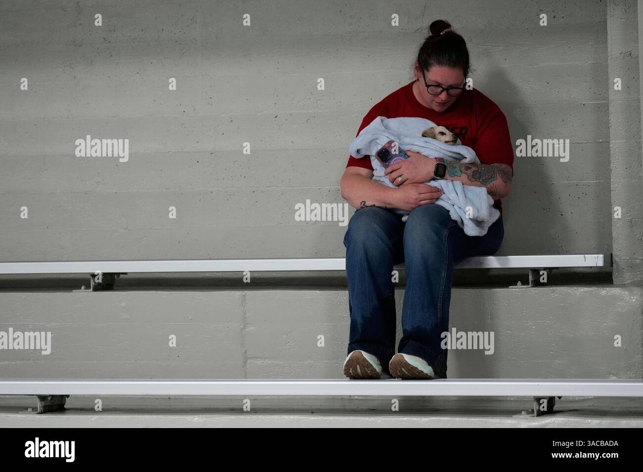 Katie Ritchie sits with her dog Maddy at a Red Cross shelter following ...